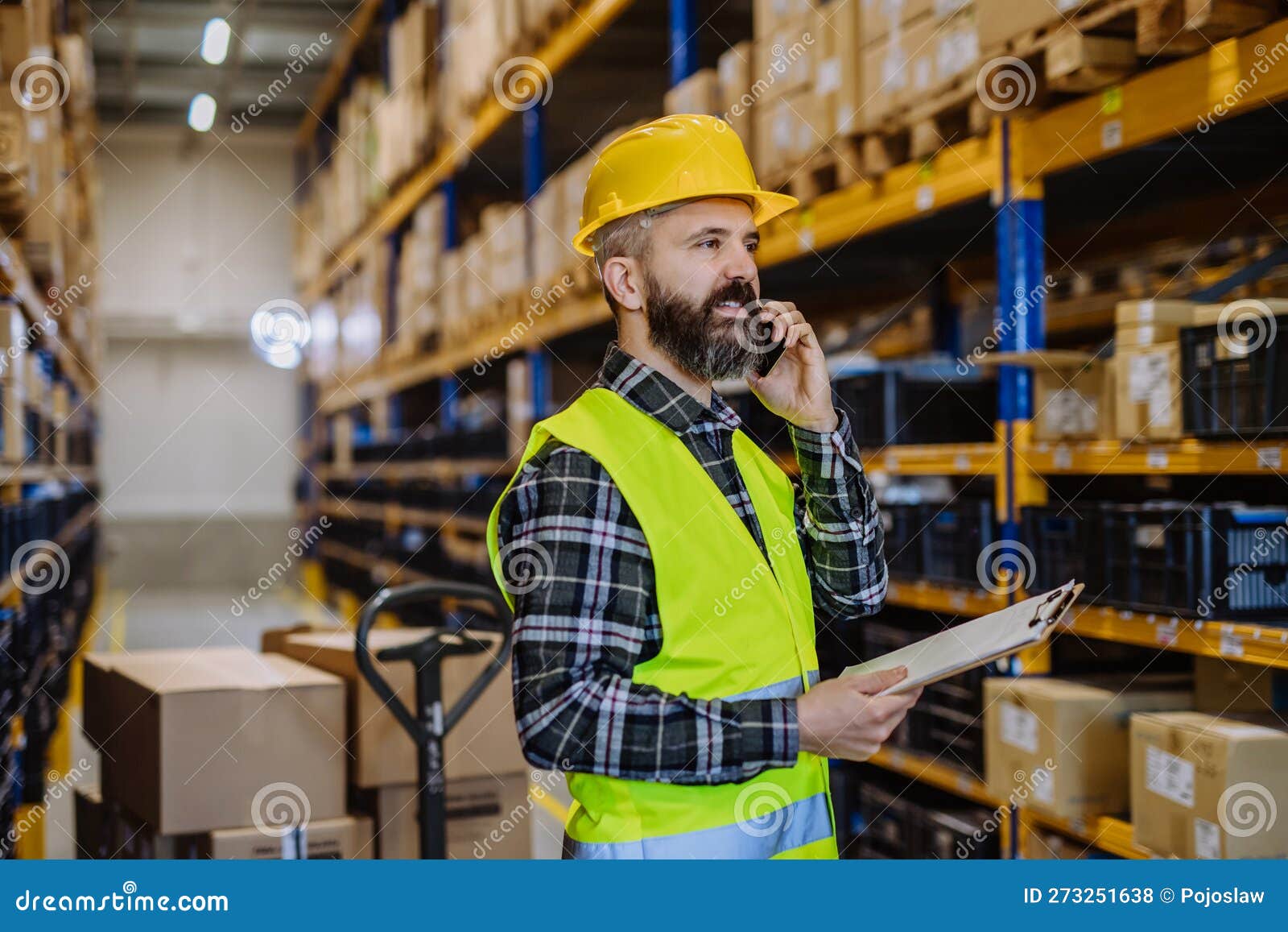 Warehouse Worker Calling and Checking Up Stuff in a Warehouse. Stock ...