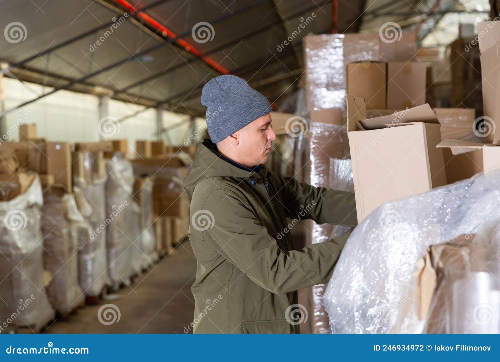 Warehouse Worker Carrying Boxes on Racks in in Warehouse Stock Photo ...