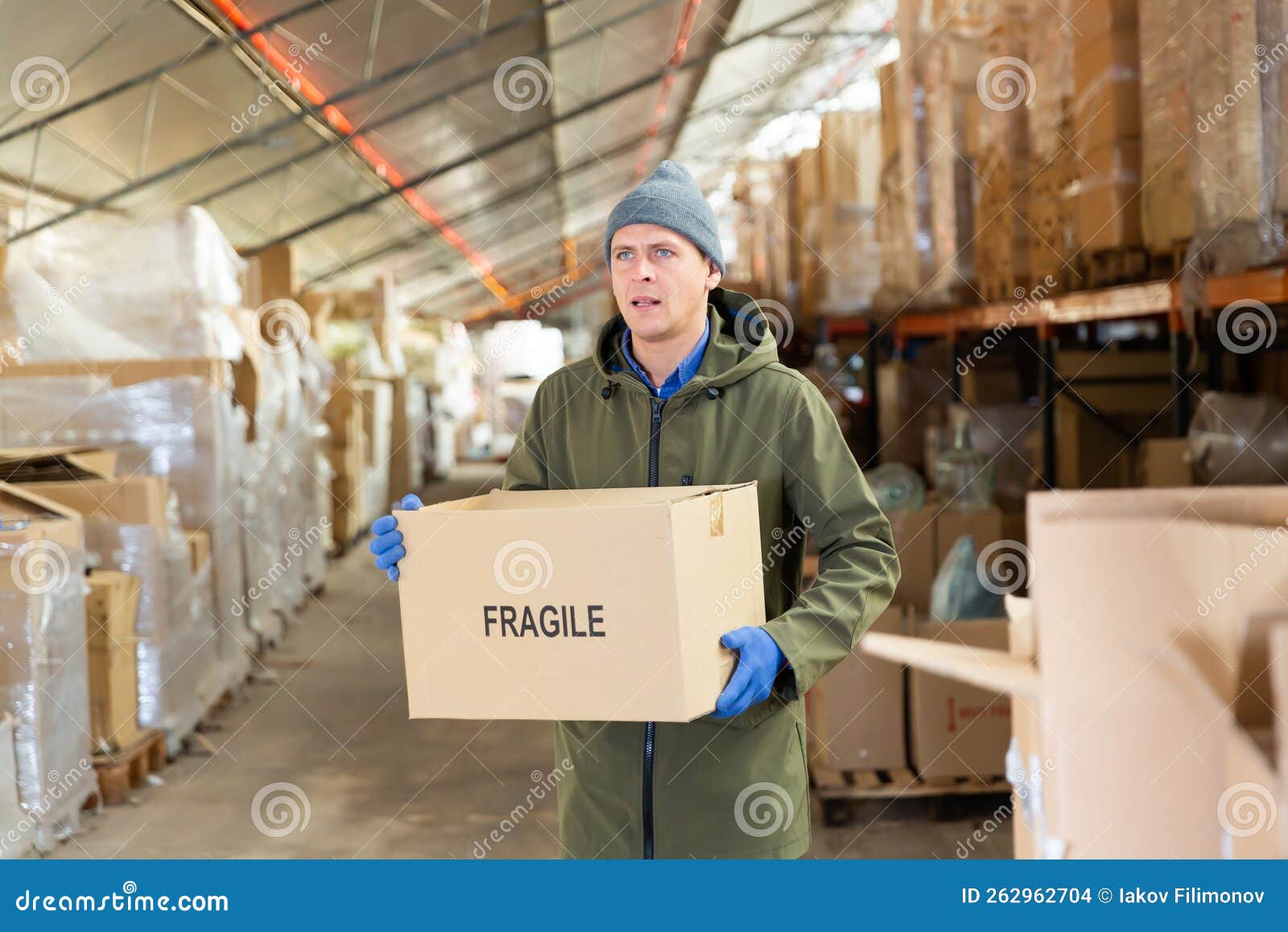 Warehouse Worker Carrying Boxes on Racks in in Warehouse Stock Photo ...