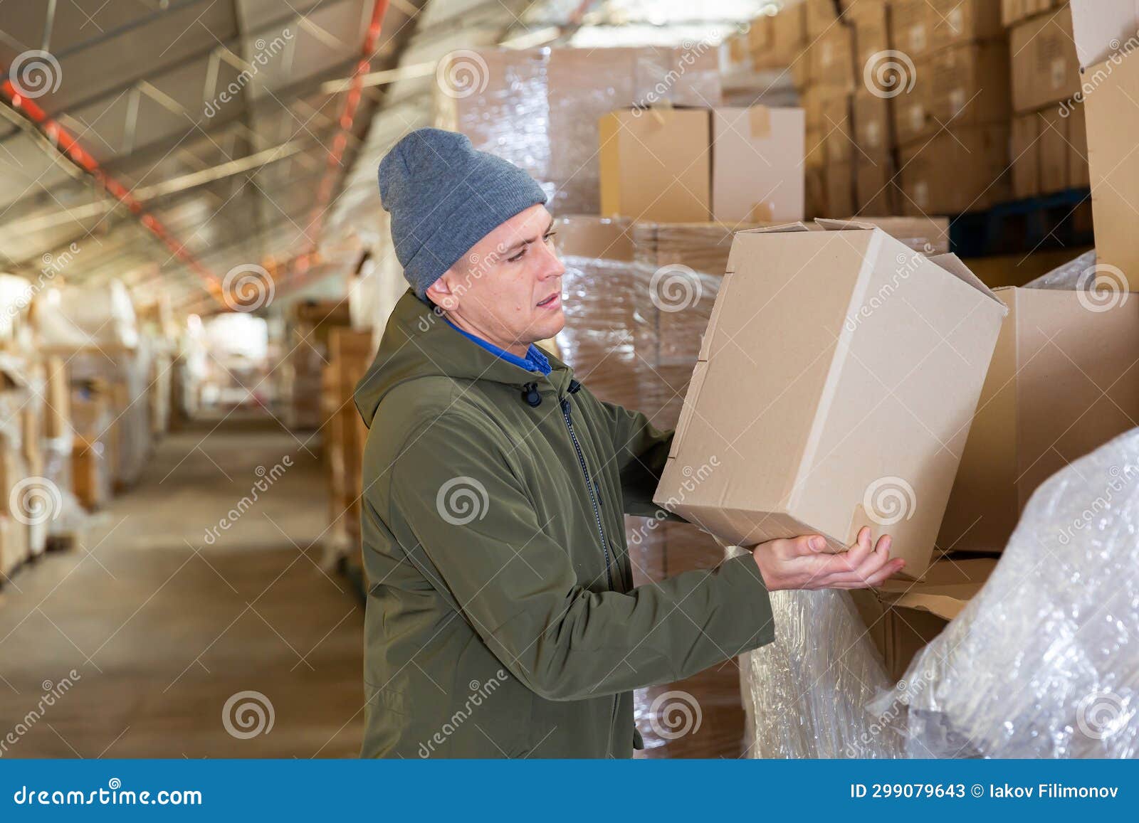 Warehouse Worker Carrying Large Box of Goods in Arehouse Stock Image ...