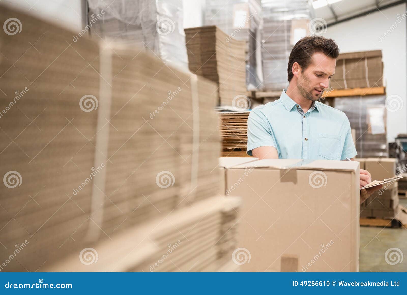 Warehouse Worker Checking His List on Clipboard Stock Photo - Image of ...