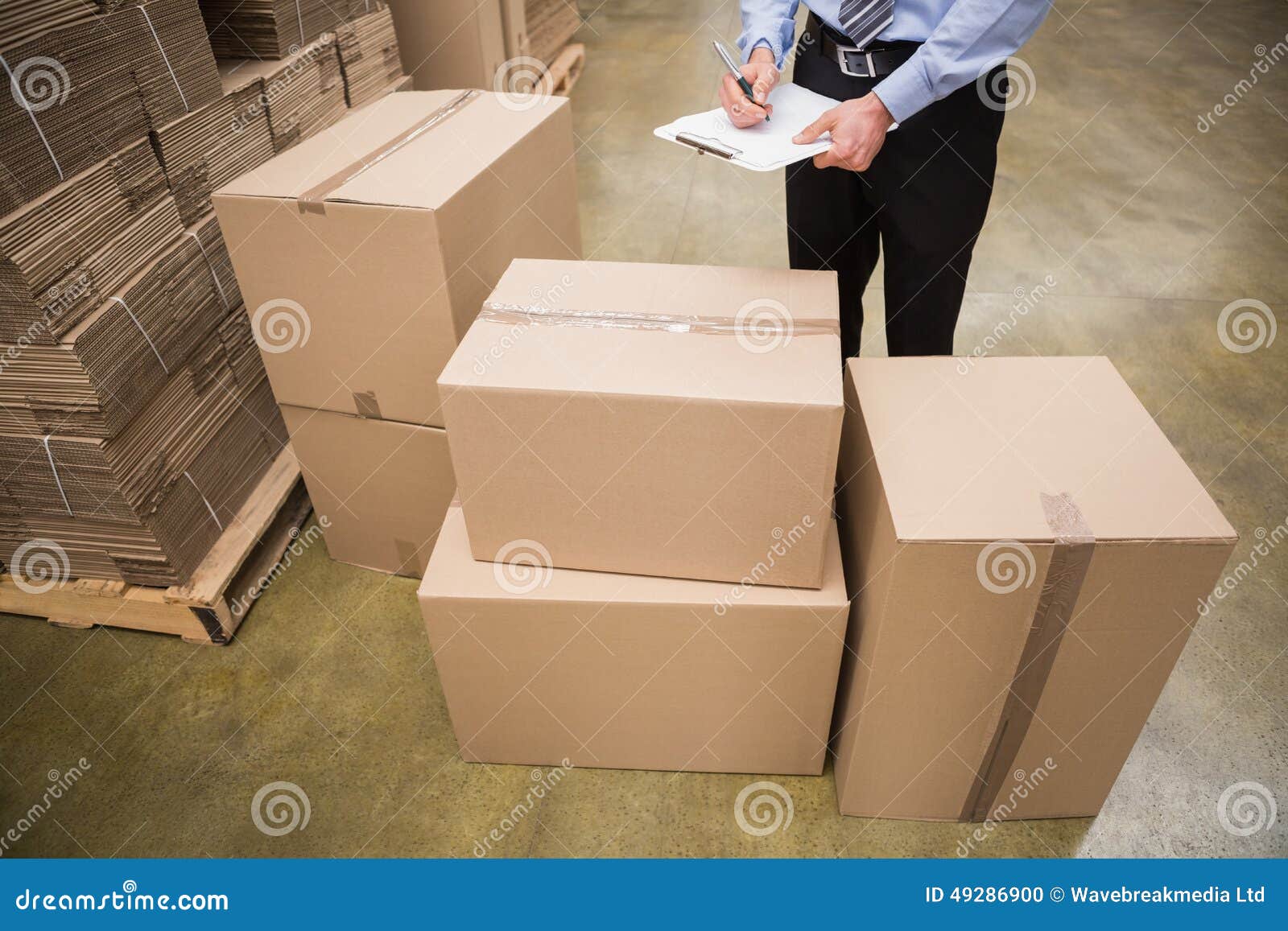 Warehouse Worker Checking His List on Clipboard Stock Photo - Image of ...
