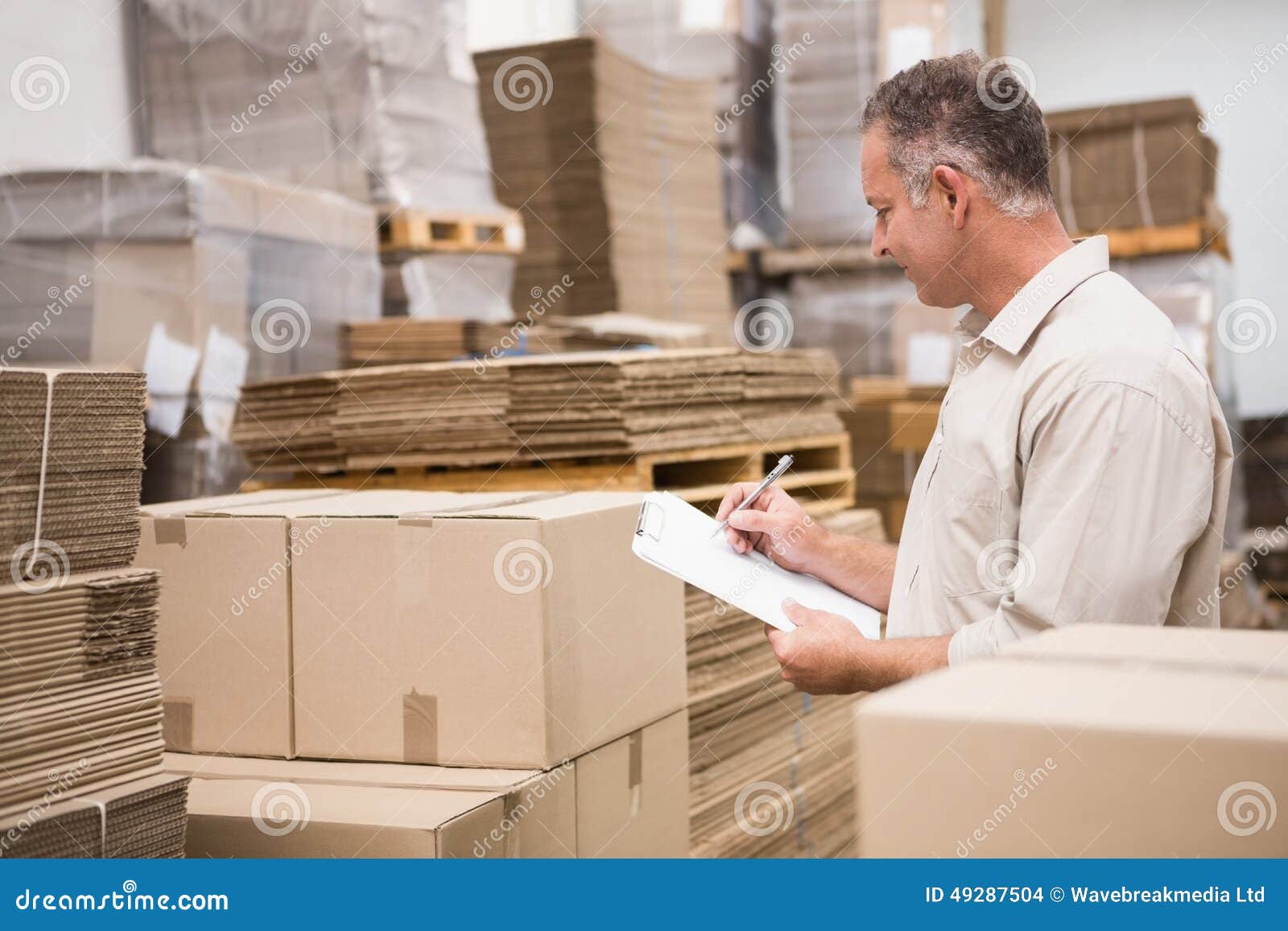 Warehouse Worker Checking His List on Clipboard Stock Photo - Image of ...