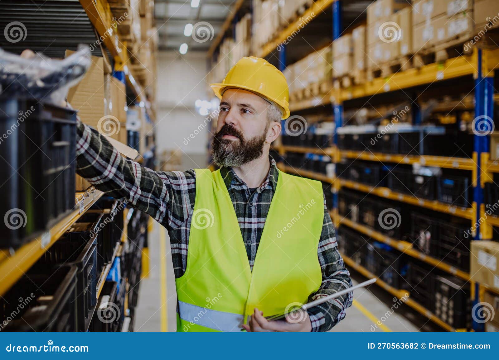 Warehouse Worker Checking Up Stuff in a Warehouse. Stock Photo - Image ...