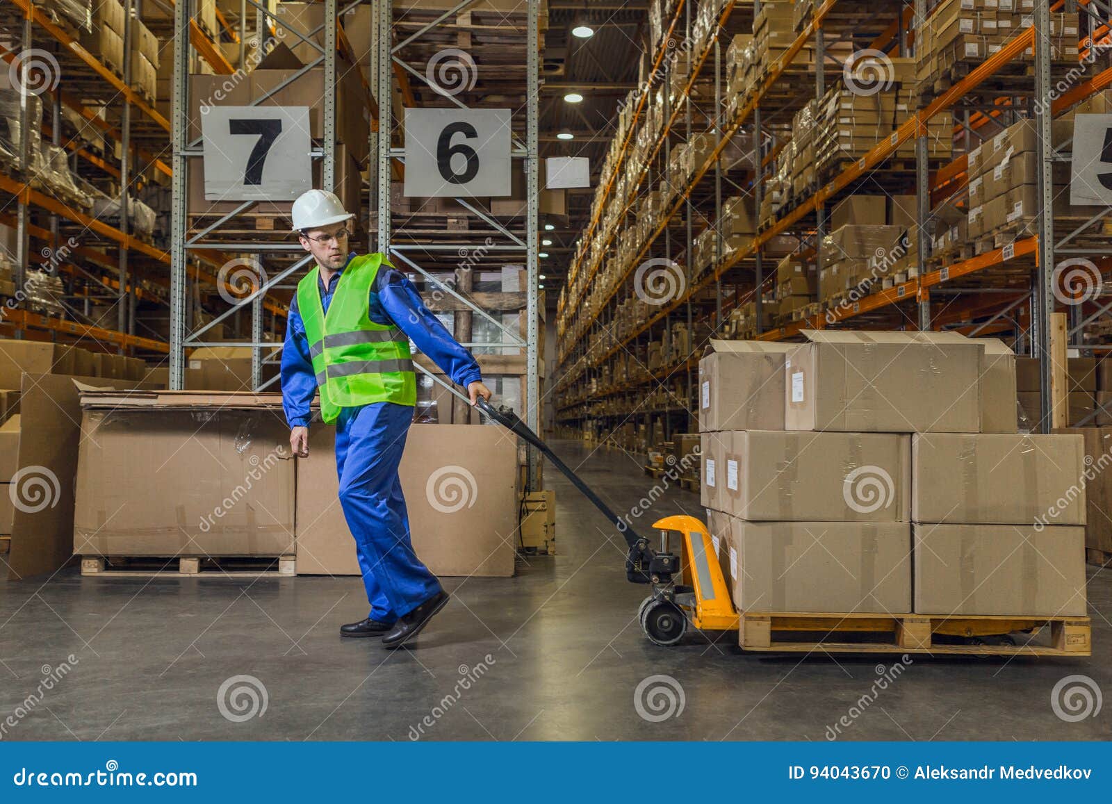 Warehouse Worker Dragging a Cart with Boxes Stock Photo - Image of ...