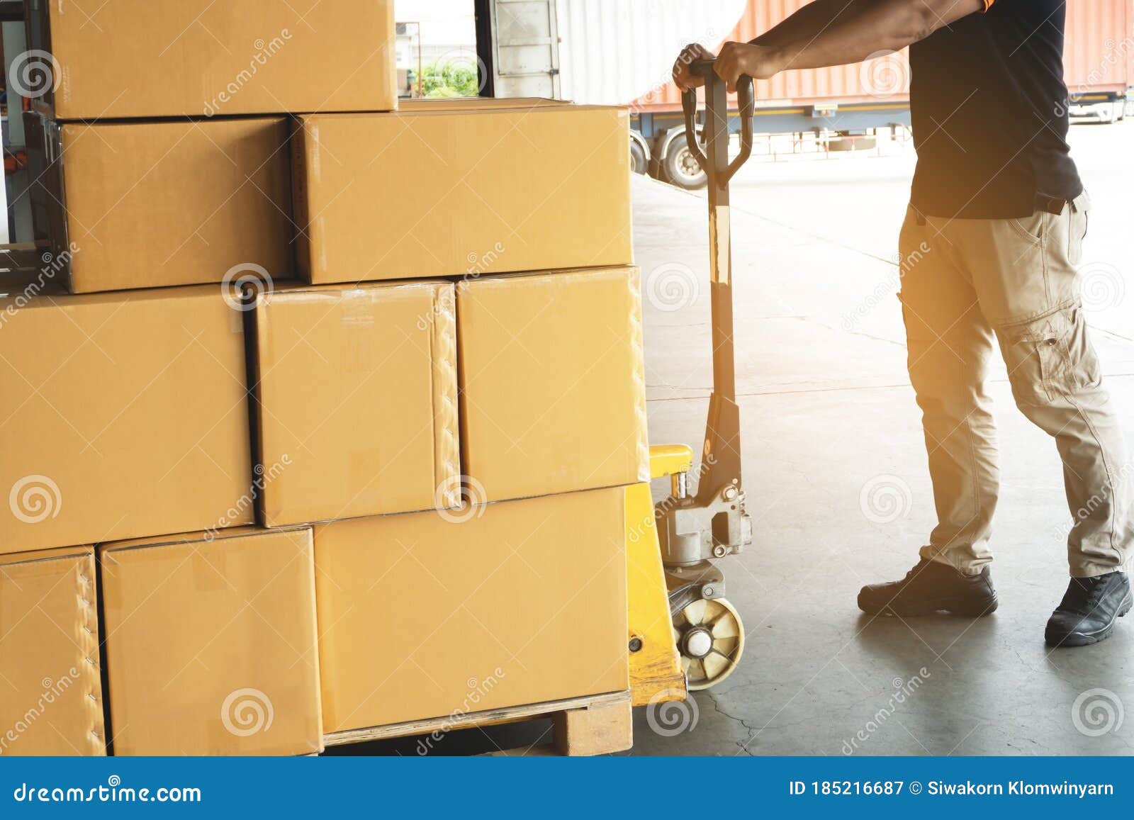 Warehouse Worker with Hand Pallet Truck Unloading Cargo Shipment Goods ...