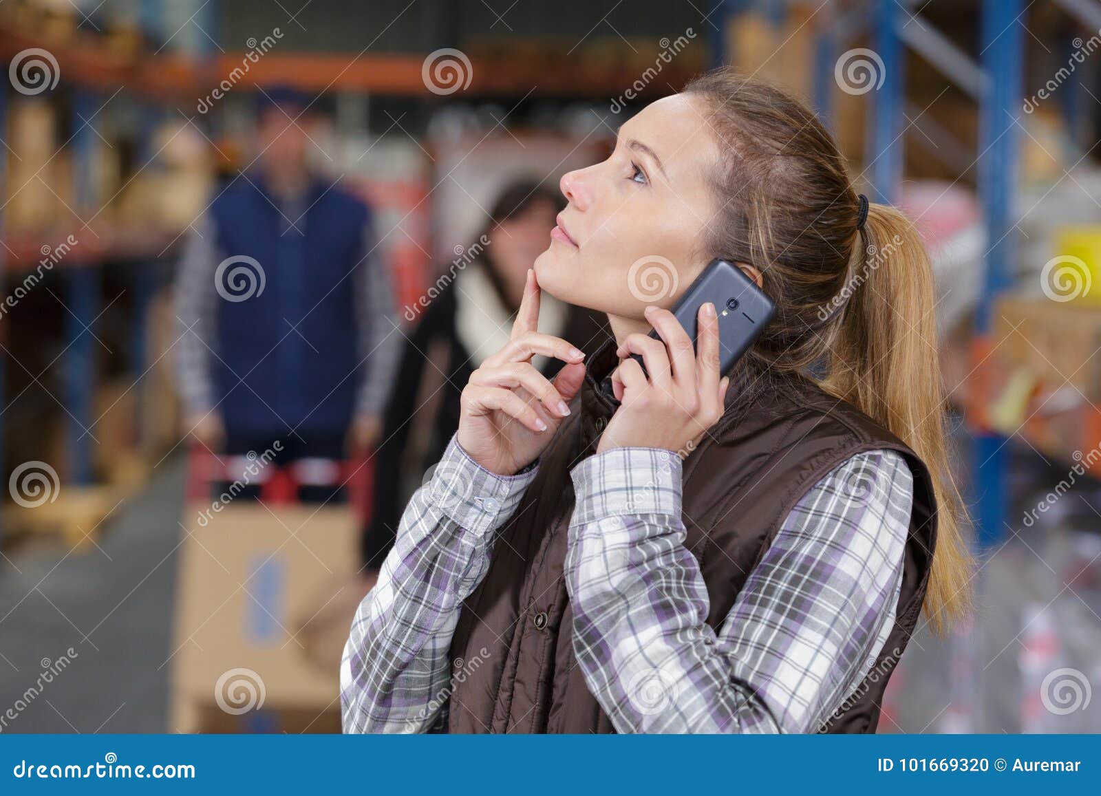 Warehouse Worker Making Call in Distribution Warehouse Stock Photo ...