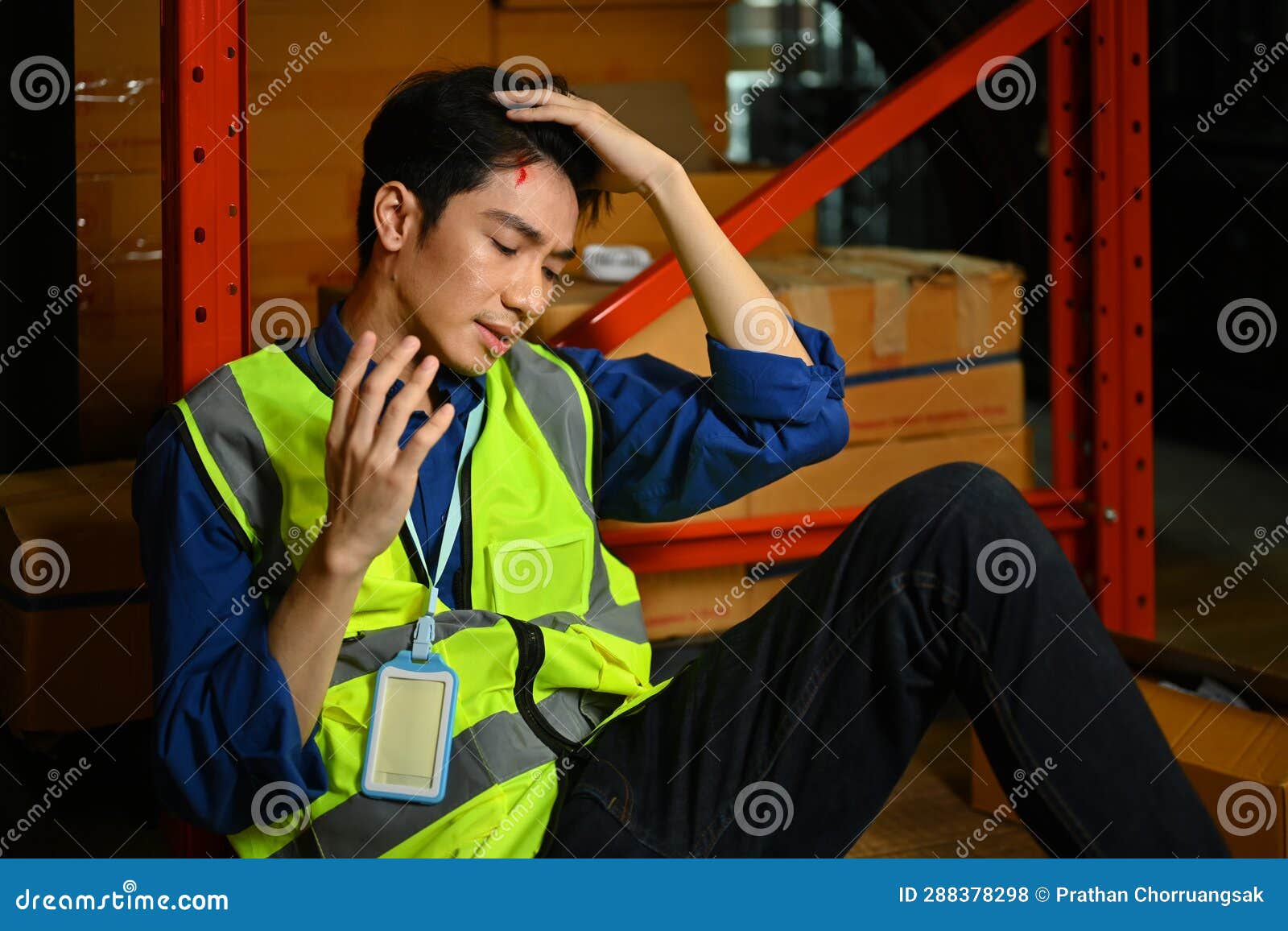 Warehouse Worker Making an Emergency Call, Asking for First Aid Team ...