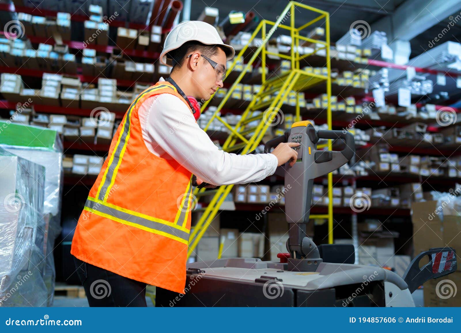 Warehouse Worker Operates a Pallet Loader. Stock Photo - Image of ...