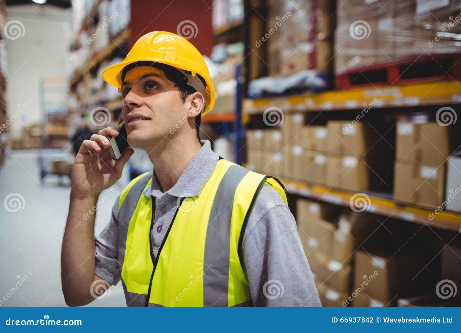 Warehouse Worker on a Phone Call Stock Photo - Image of smartphone ...