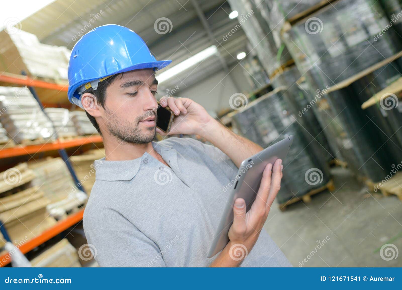 Warehouse Worker on Phone Holding Tablet Stock Image - Image of ...
