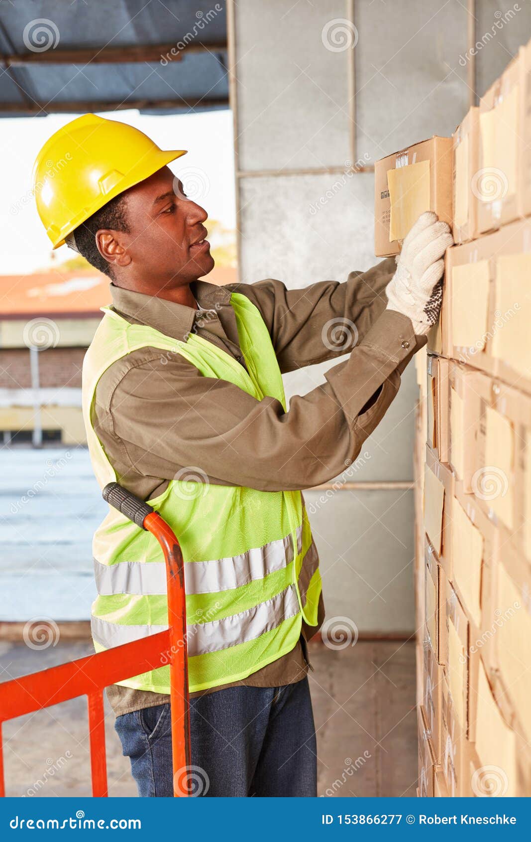 Warehouse Worker Picks Up a Package from the Warehouse Stock Image ...