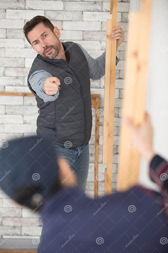 Warehouse Worker Pointing with Finger at Doors Stock Photo - Image of ...