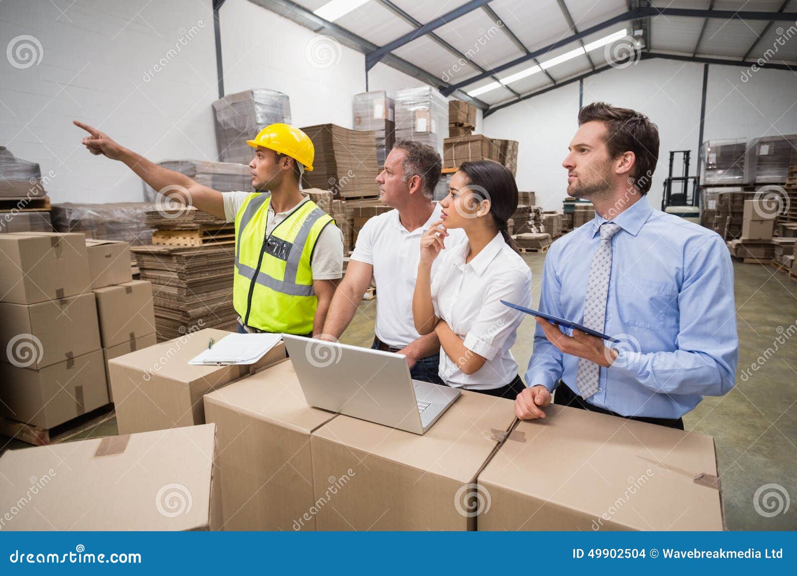 Warehouse Worker Pointing Something To His Colleagues Stock Photo ...