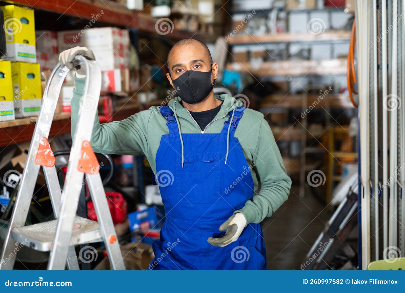 Warehouse Worker in Protective Mask Stands Next To Stepladder and Tool ...