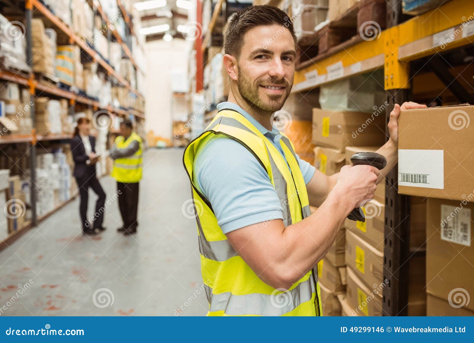 Warehouse Worker Scanning Box while Smiling at Camera Stock Photo ...