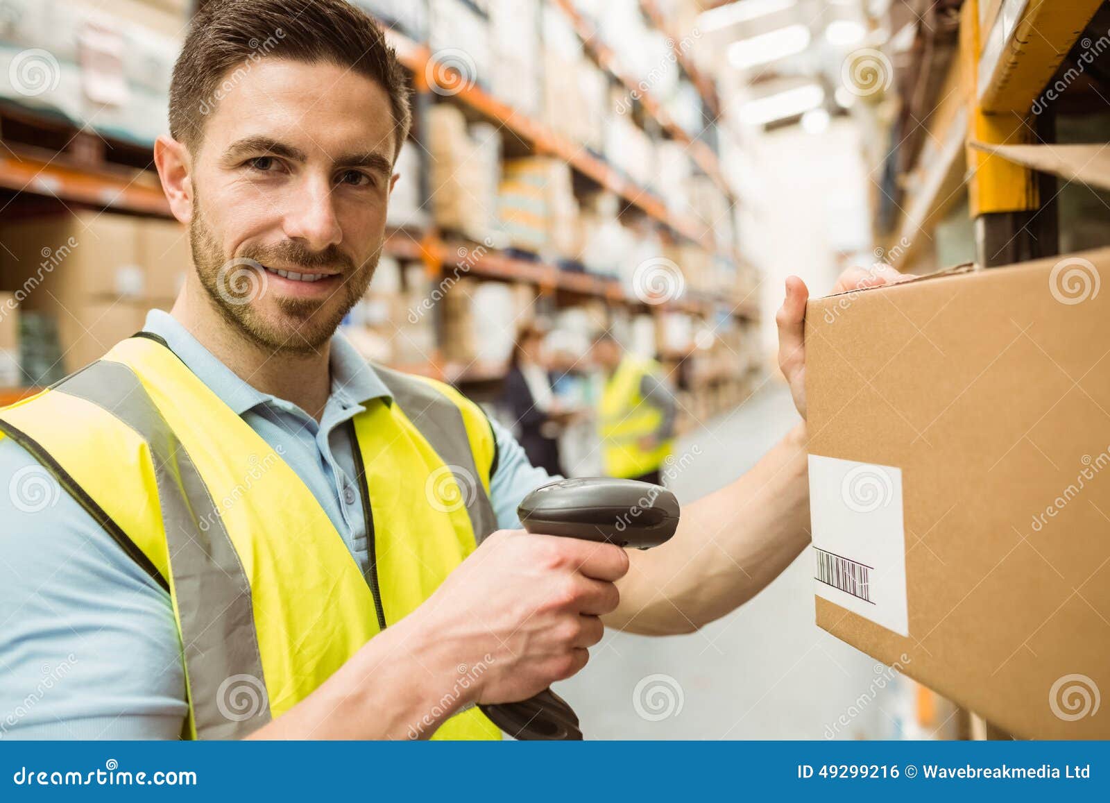 Warehouse Worker Scanning Box while Smiling at Camera Stock Photo ...