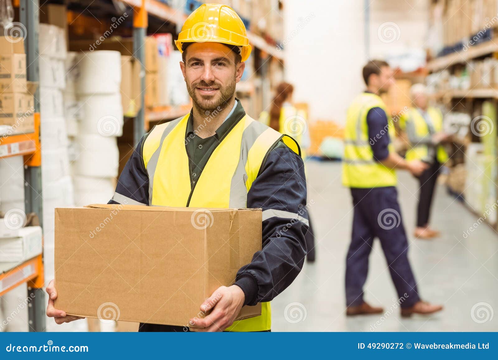Warehouse Worker Smiling at Camera Carrying a Box Stock Photo - Image ...