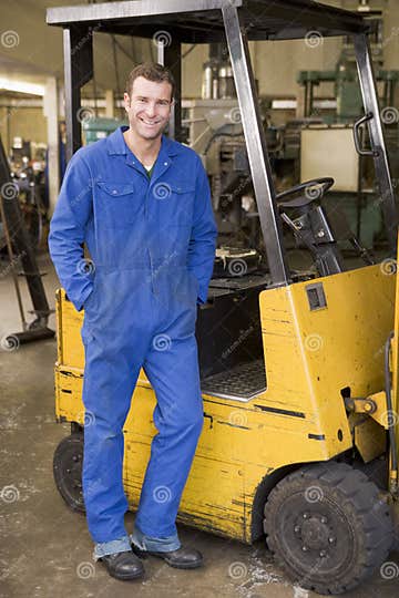 Warehouse Worker Standing by Forklift Stock Image - Image of ...