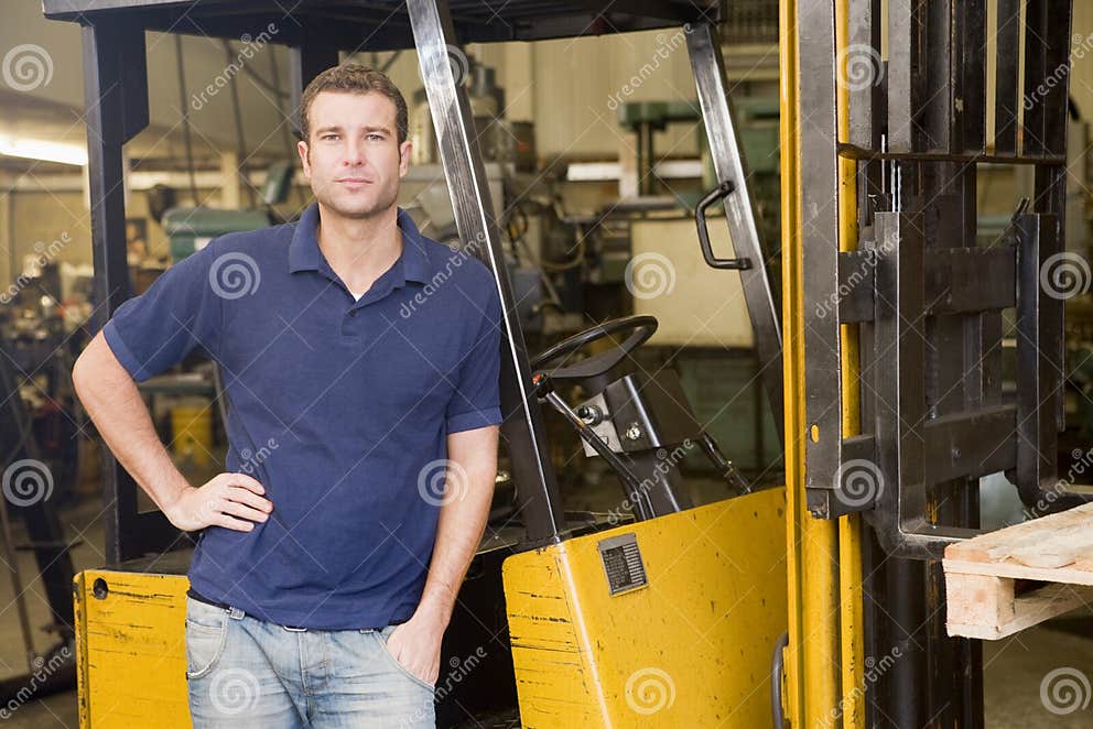 Warehouse Worker Standing by Forklift Stock Image - Image of length ...