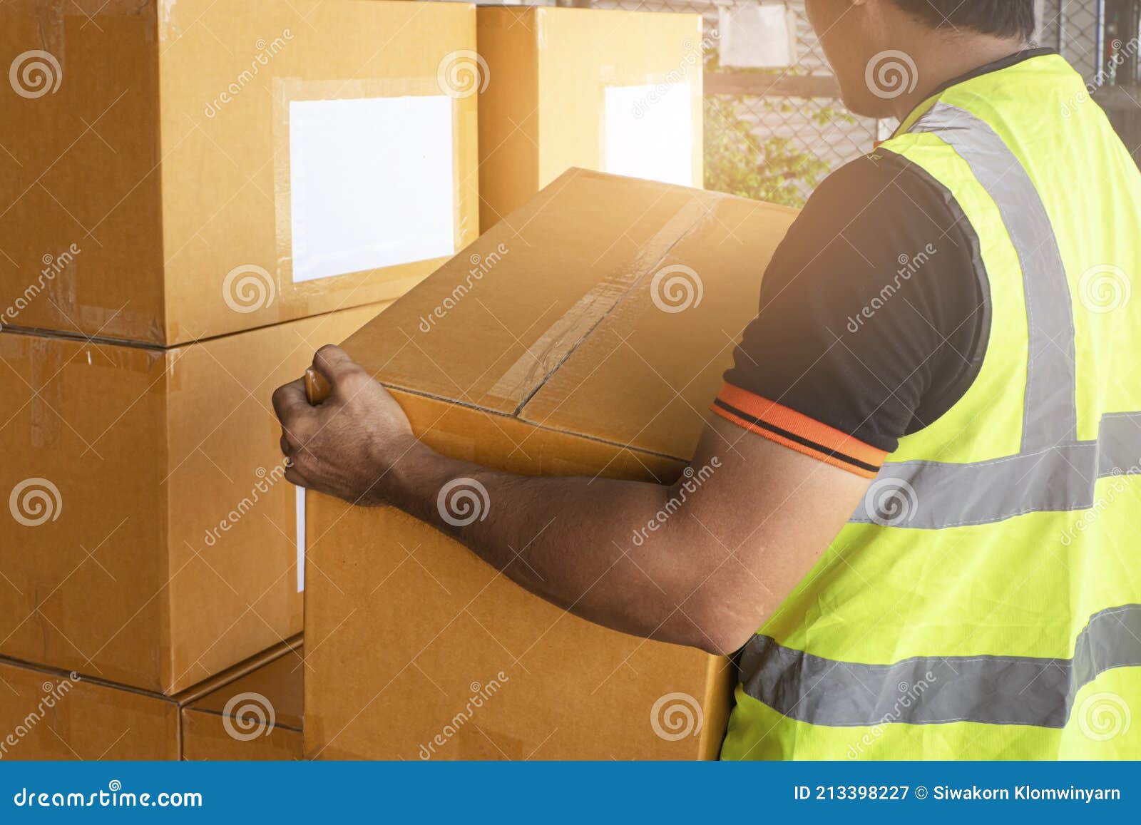 Warehouse Worker Stcking Cardboard Boxes at Storage Warehouse. Shipment ...