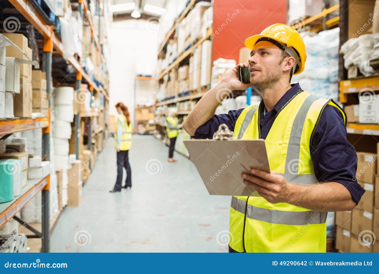 Warehouse Worker Talking on the Phone Holding Clipboard Stock Photo ...