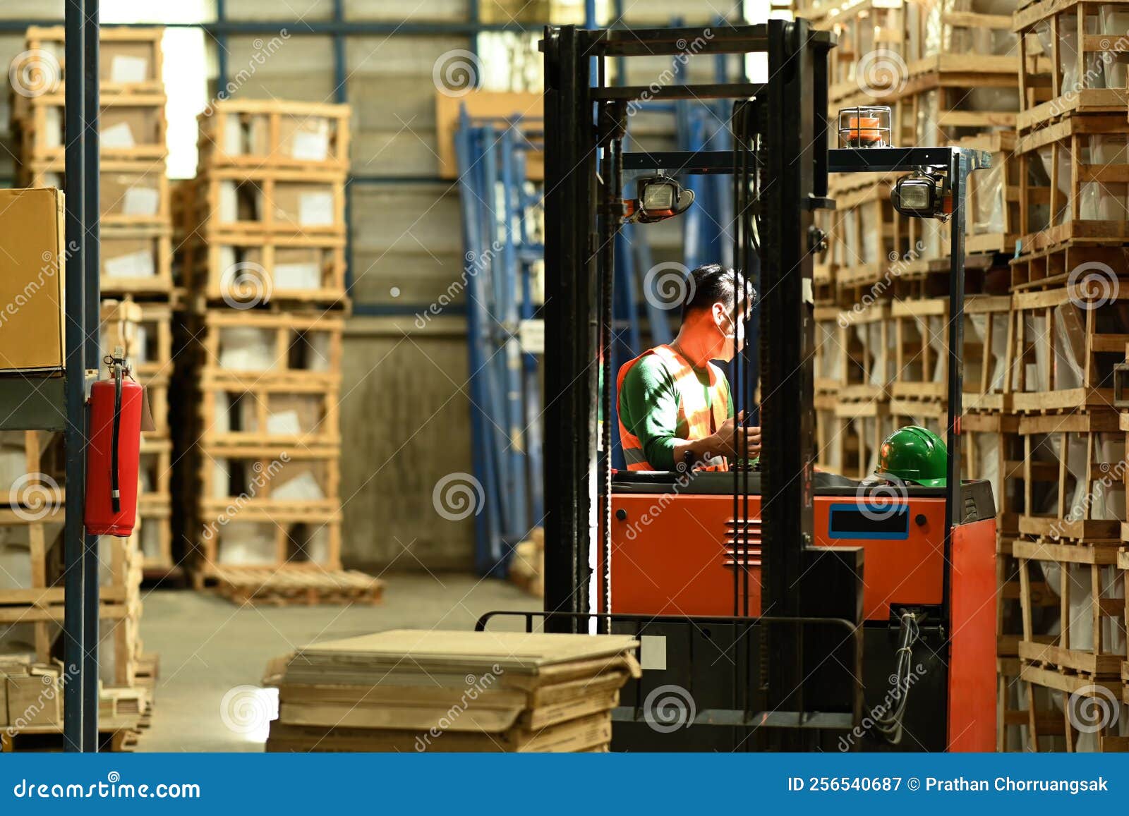 Warehouse Worker in Uniform Loading Cardboard Boxes with Forklift in ...