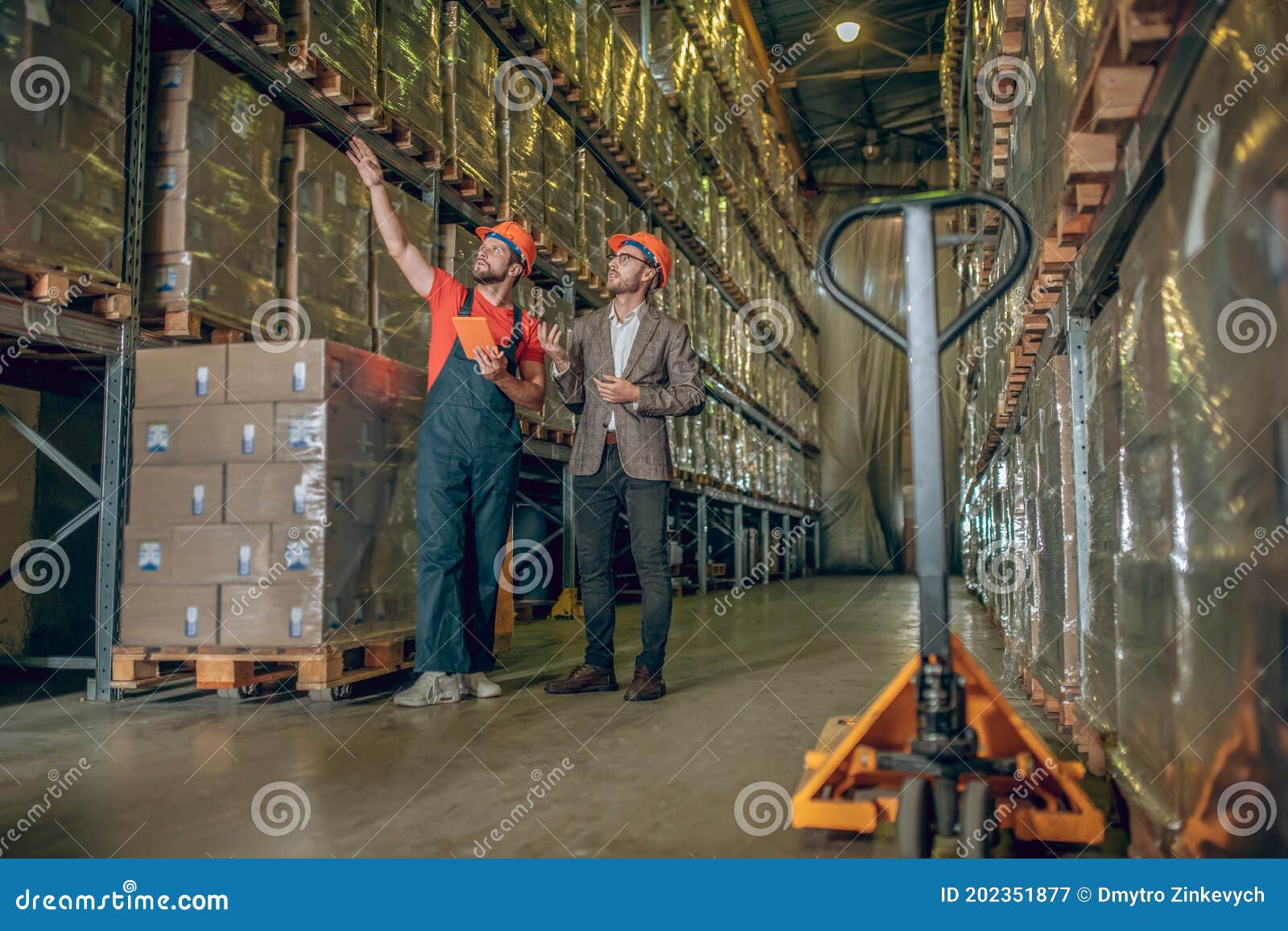 Warehouse Worker in Working Clothes Showing Something To Manager Stock ...