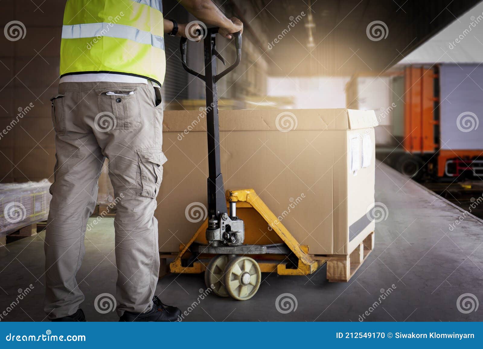 Warehouse Worker Working with Hand Pallet Truck Loading Heavy Boxes on ...