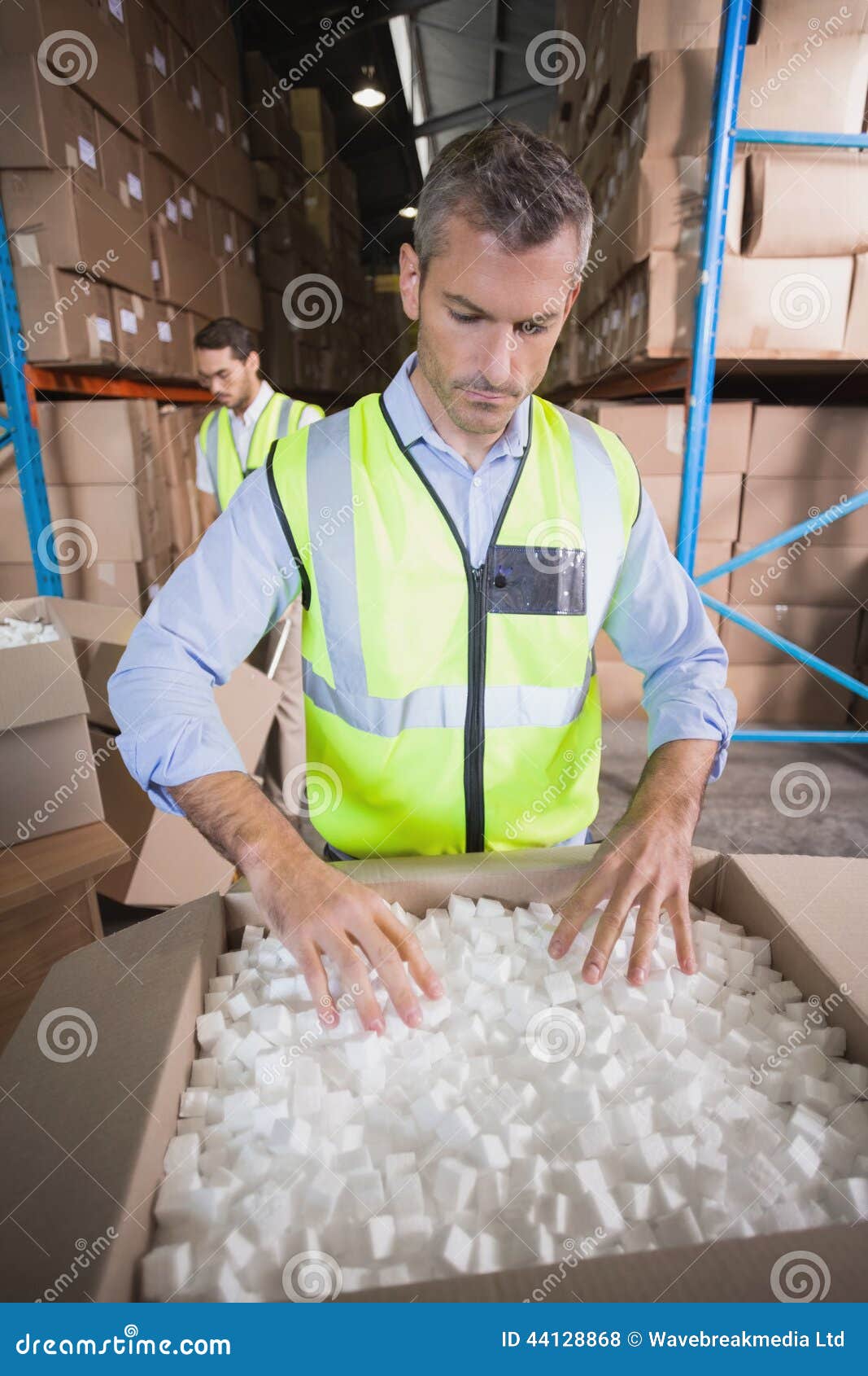 Warehouse Worker in Yellow Vest Preparing a Shipment Stock Photo ...
