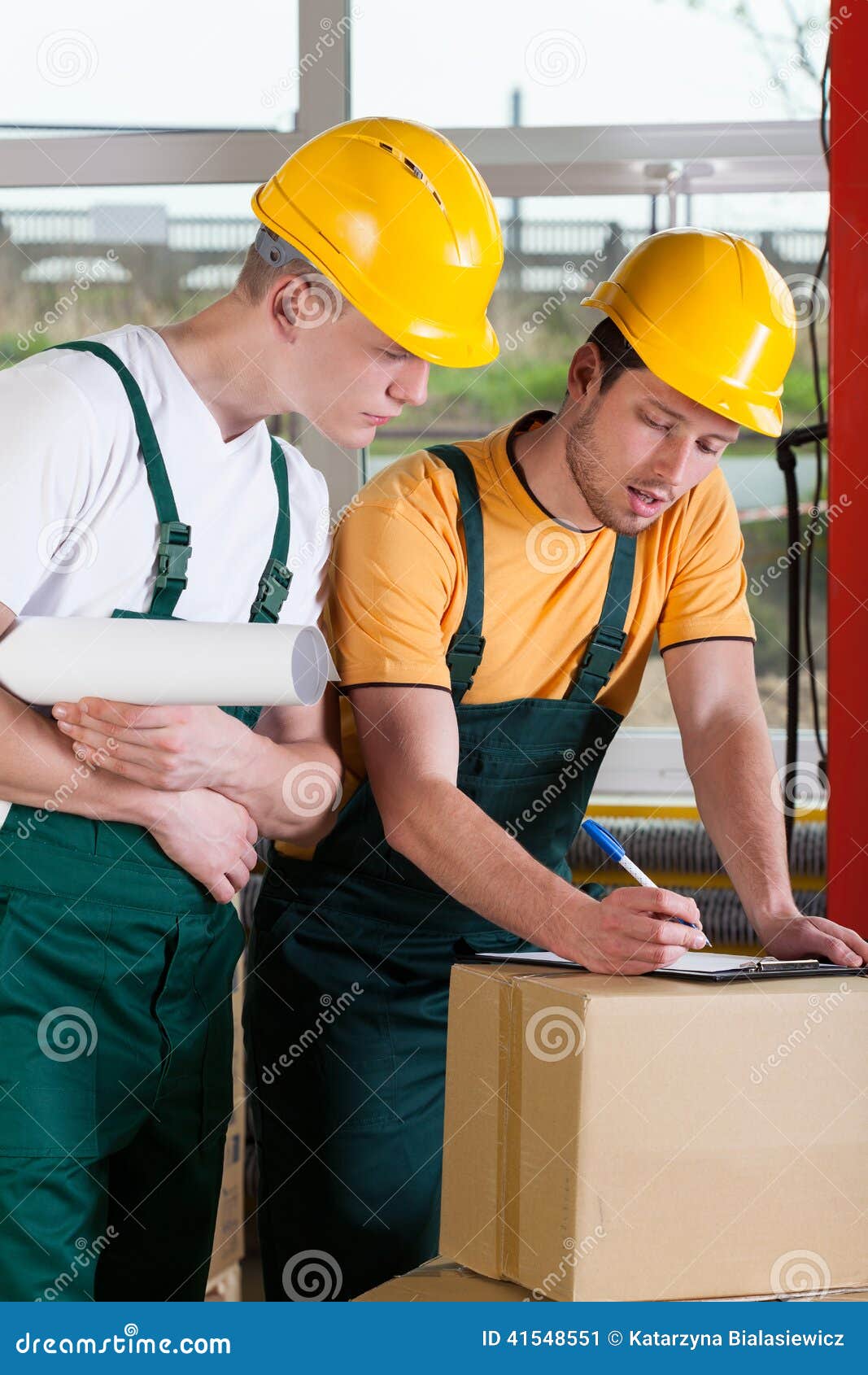 Warehouse Workers Check Stock Details In Storage Area Putting Them On ...
