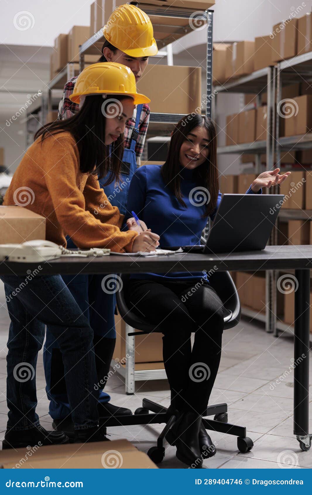 Warehouse Workers Checking Order Pick Ticket on Laptop Stock Photo ...