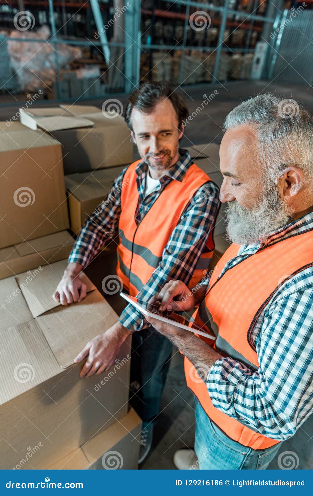 Smiling Warehouse Workers with Digital Tablet Working Together Stock ...