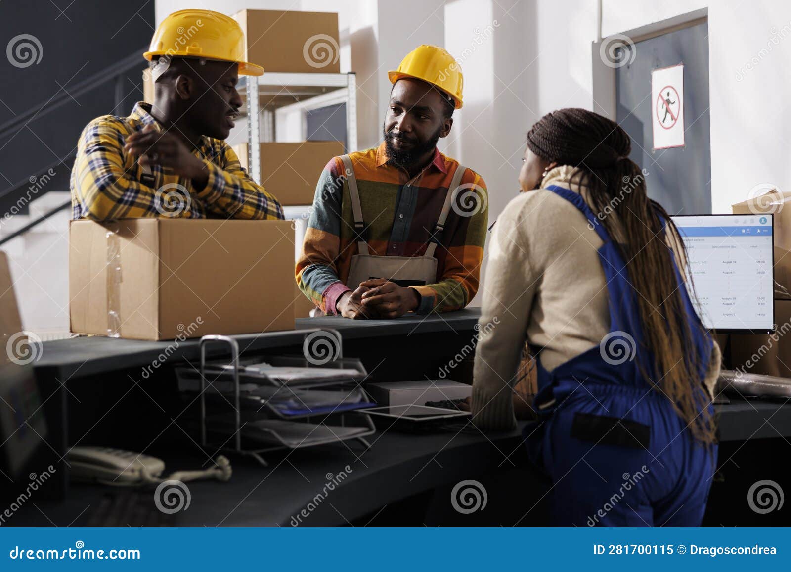 Warehouse Workers Holding Parcel at Reception, Discussing Package ...
