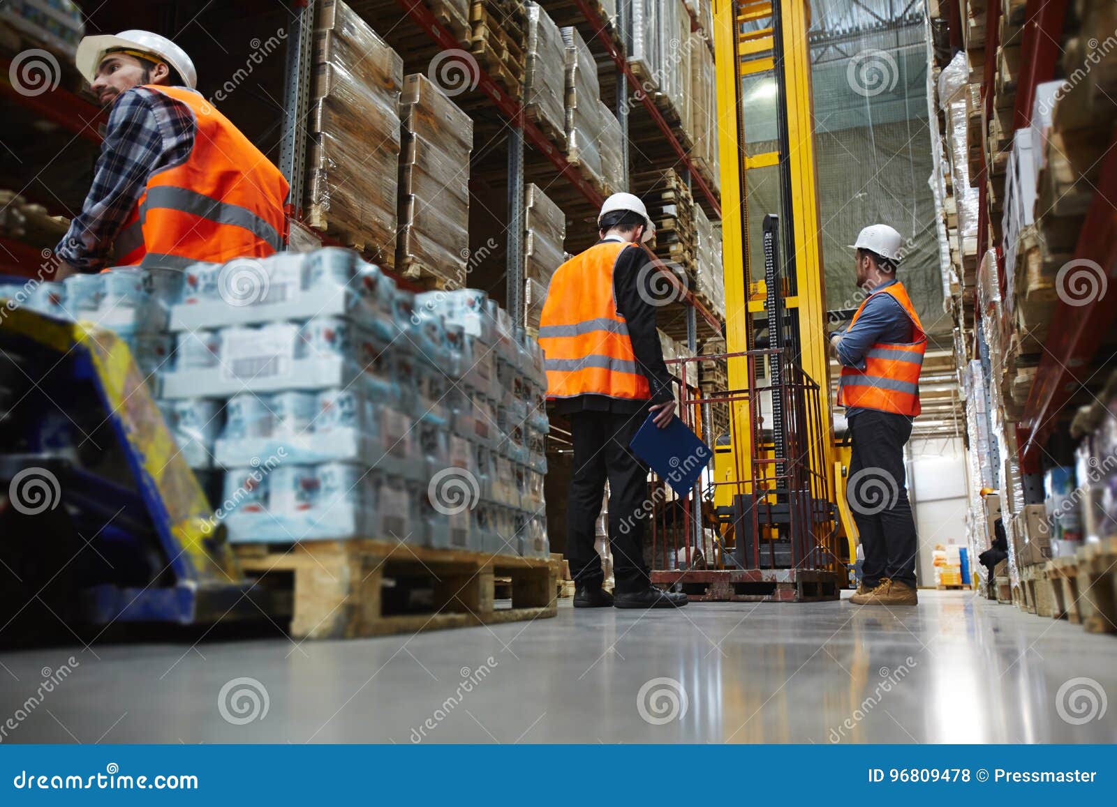 Warehouse Workers Loading Goods on Reach Fork Truck Stock Photo - Image ...