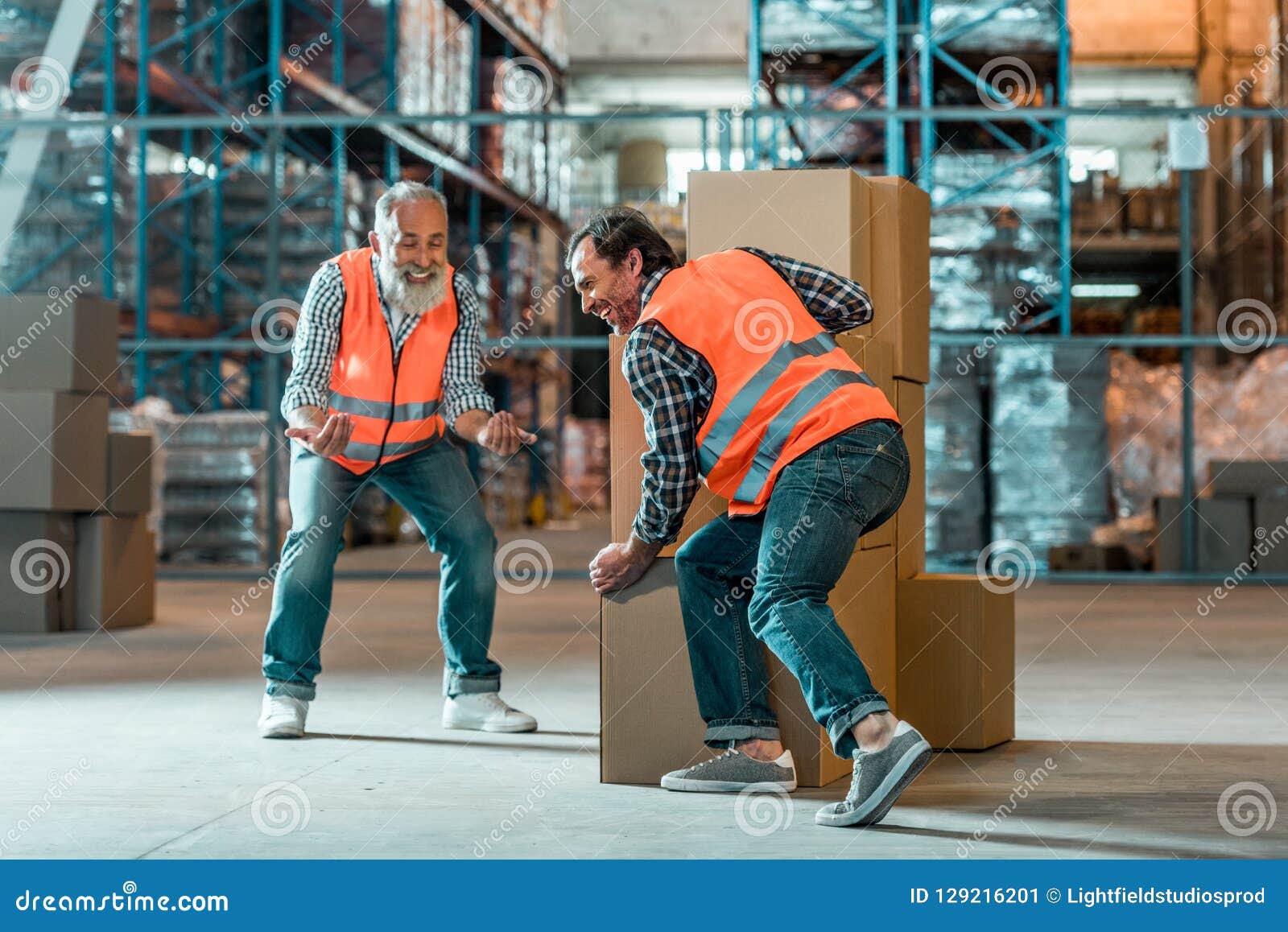 Smiling Bearded Worker Looking at Colleague Moving Boxes Stock Image ...