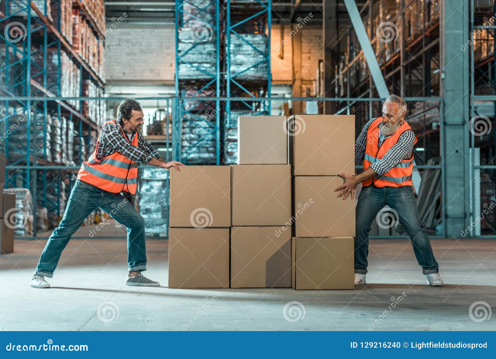 Warehouse Workers Moving Boxes while Working Together Stock Photo ...