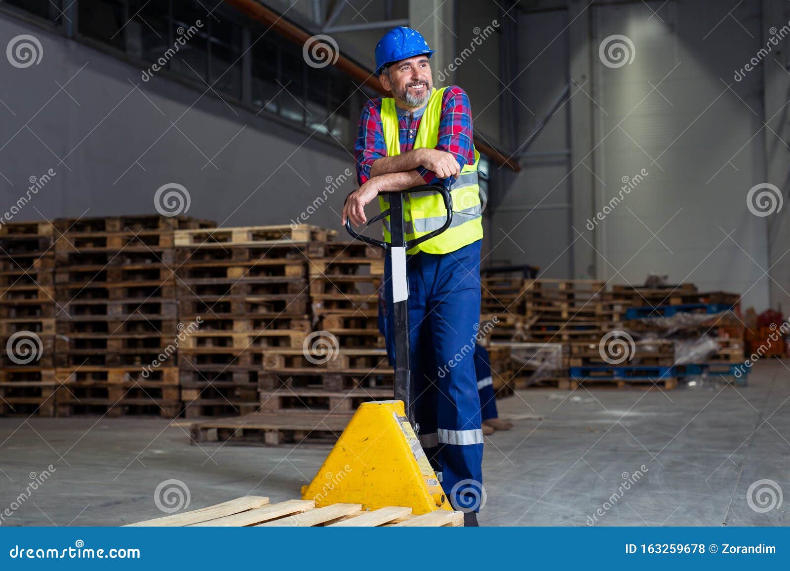 Warehouse Workers Pulling a Pallet Truck. Stock Photo - Image of ...