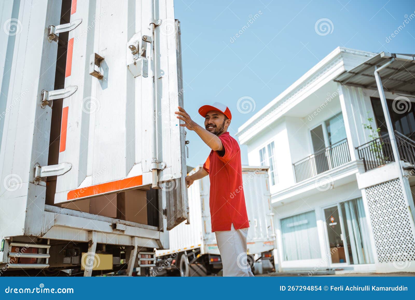 Warehouse Workers in Red Closing the Door of a Container Stock Photo ...