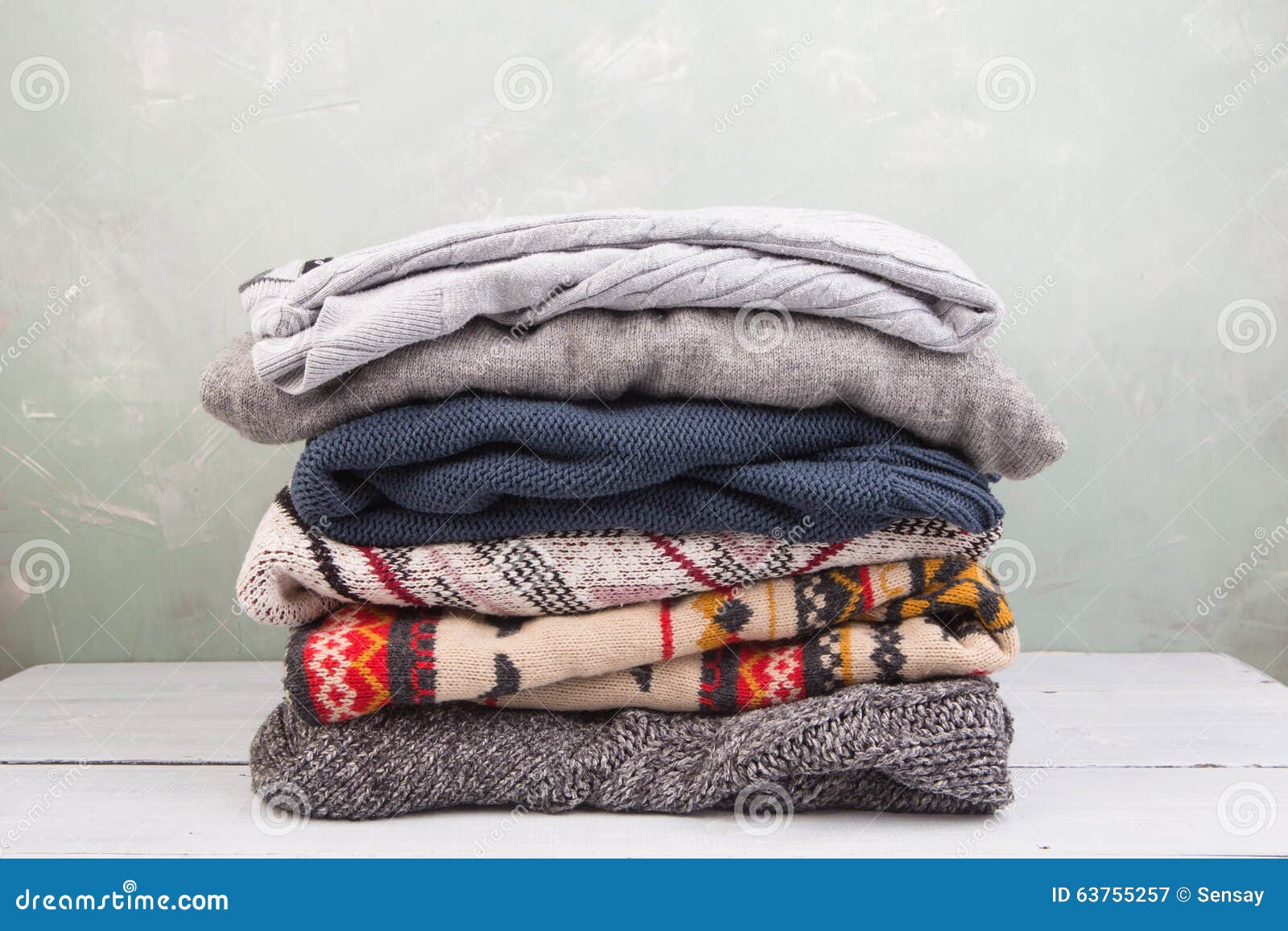 Warm Sweaters Stacked on Wooden Table Stock Image - Image of clothing ...