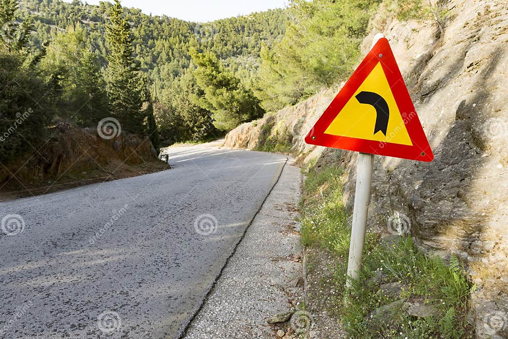 Warning Sign for Dangerous Left Turn Stock Photo - Image of forest ...