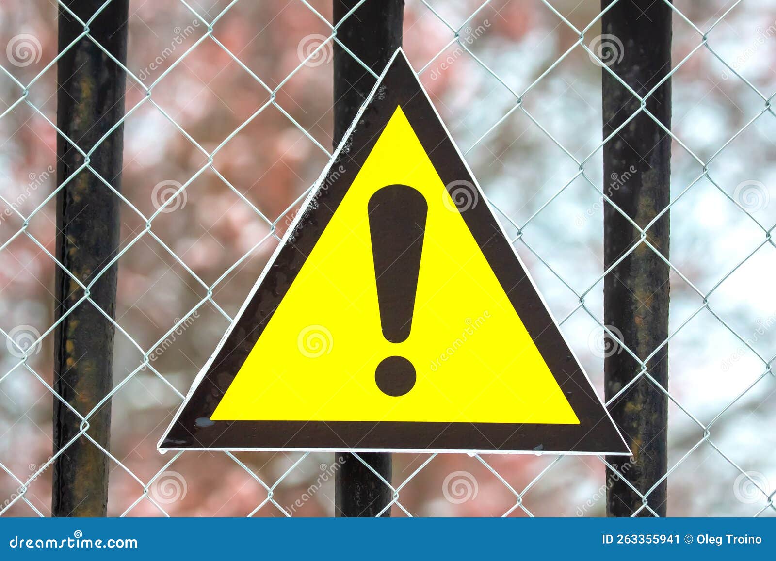 Warning Sign in the Form of a Triangle on a Metal Mesh Fence Stock ...