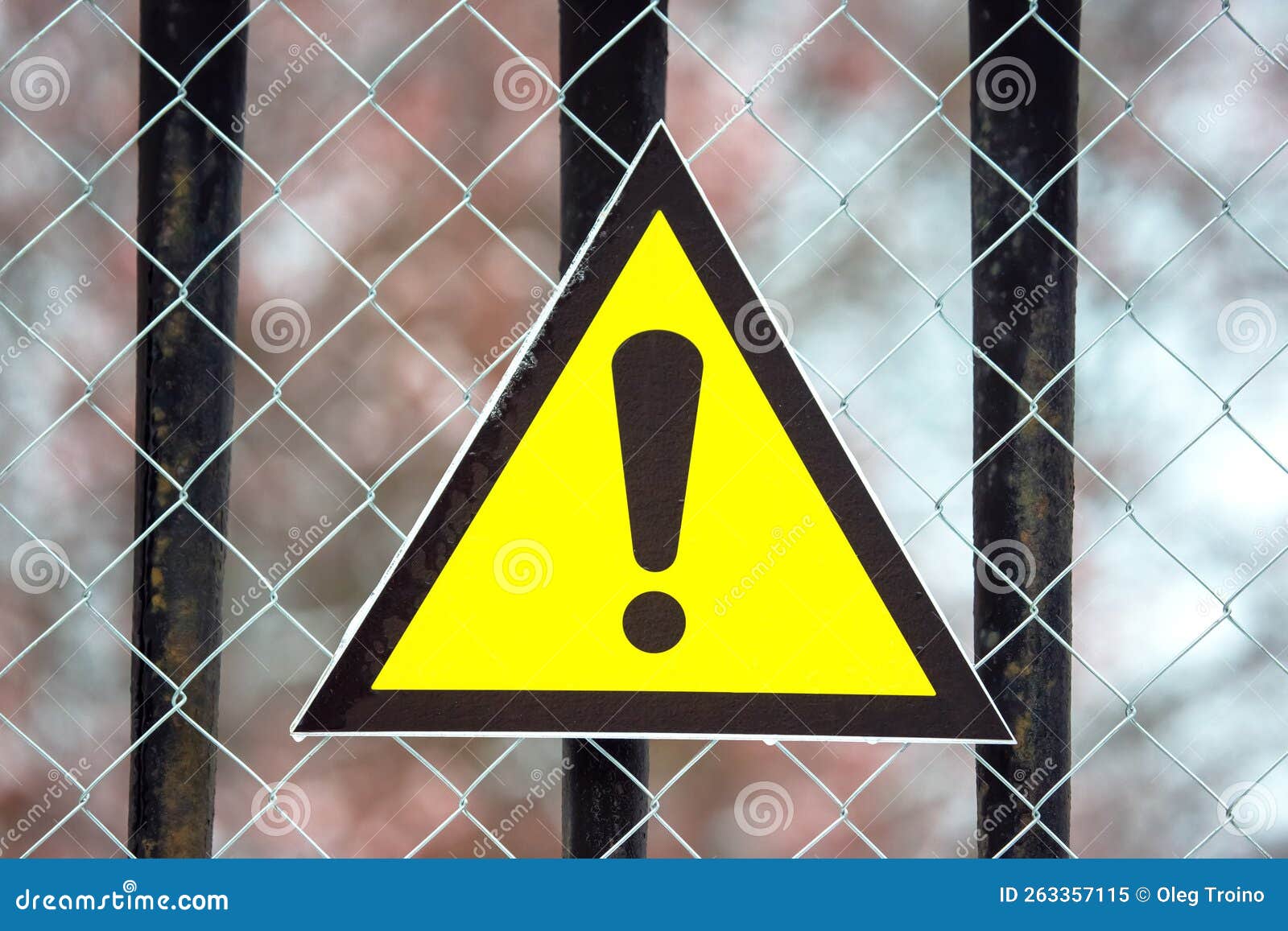 Warning Sign in the Form of a Triangle on a Metal Mesh Fence Stock ...