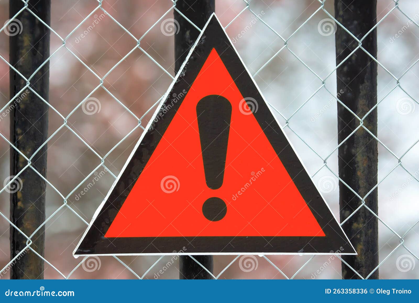 Warning Sign in the Form of a Triangle on a Metal Mesh Fence Stock ...