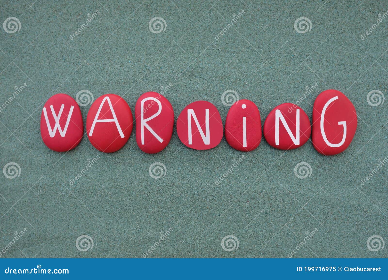 Warning Text Composed with Red Colored Stone Letters Over Green Sand ...