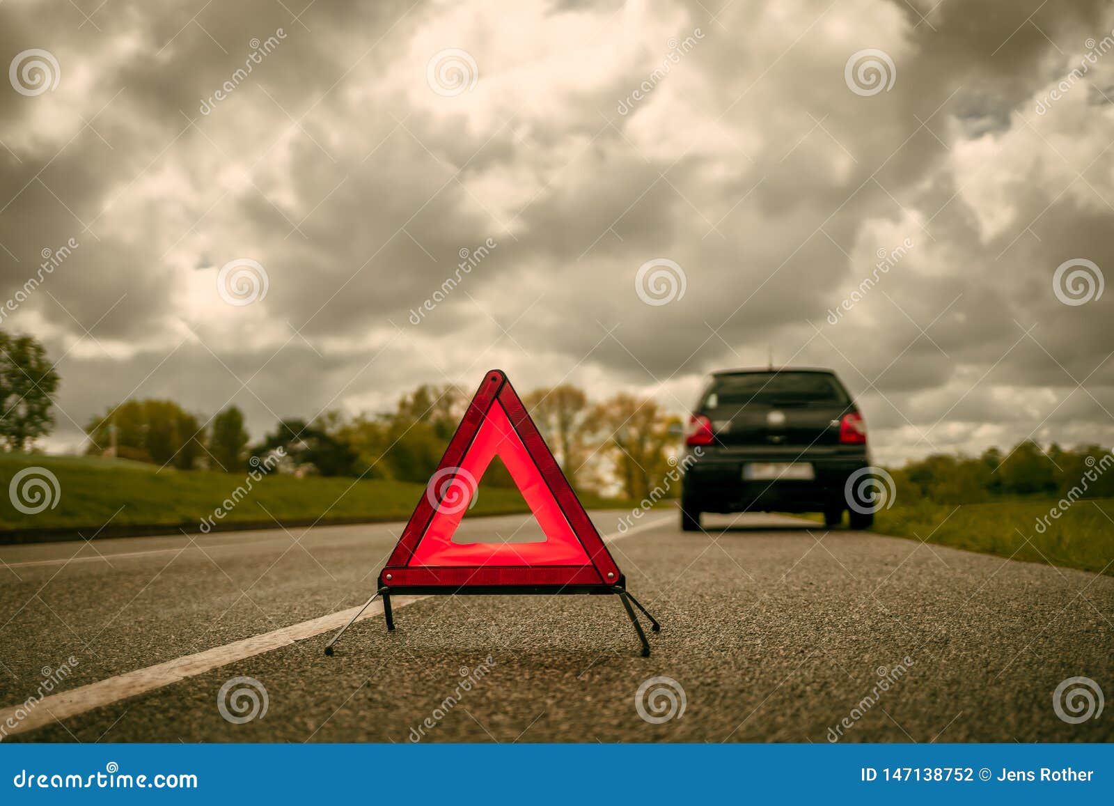 A Warning Triangle in Front of a Car with a Breakdown on a Side Strip ...