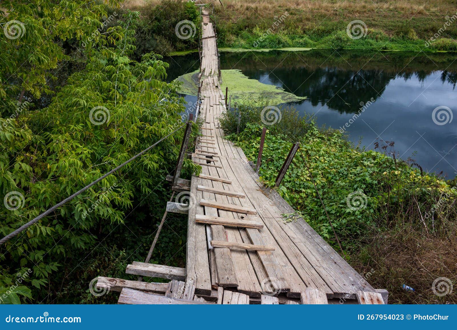 Warped and Lying on the Water Footbridge Across the River Stock Image ...