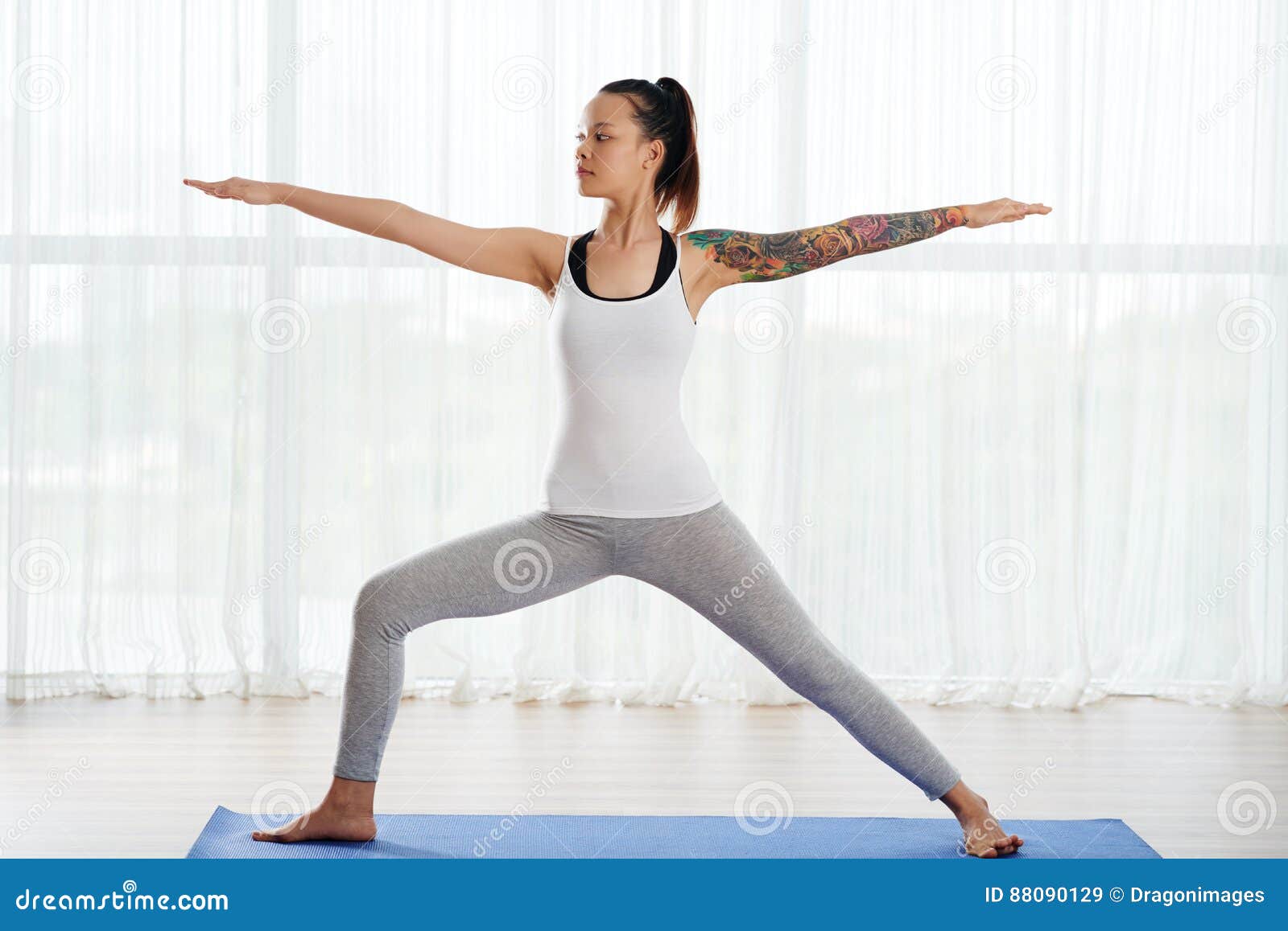 Warrior position stock image. Image of woman, young, indoors - 88090129