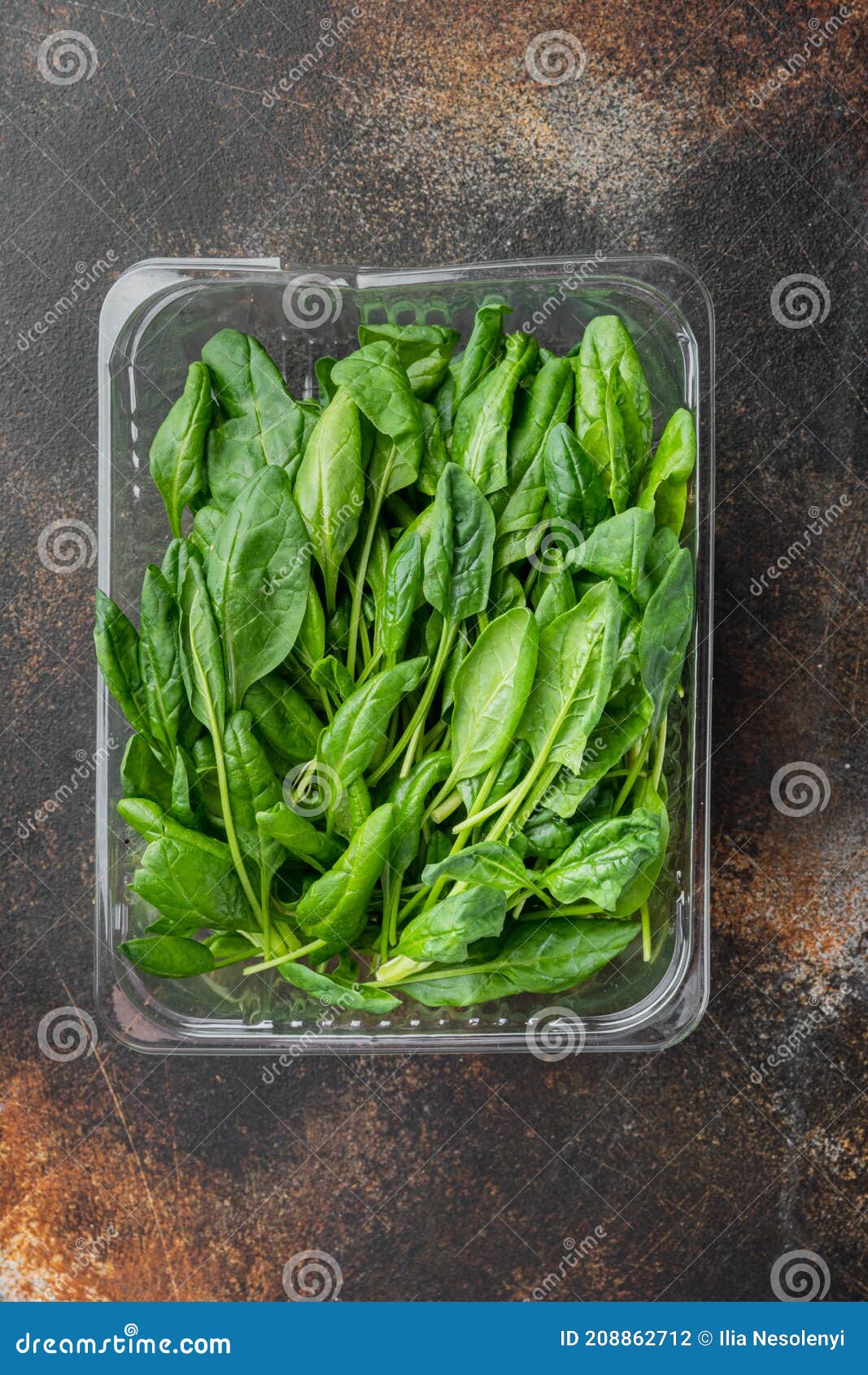 Washed Fresh Mini Spinach on Old Dark Rustic Background in Plastic Pack ...