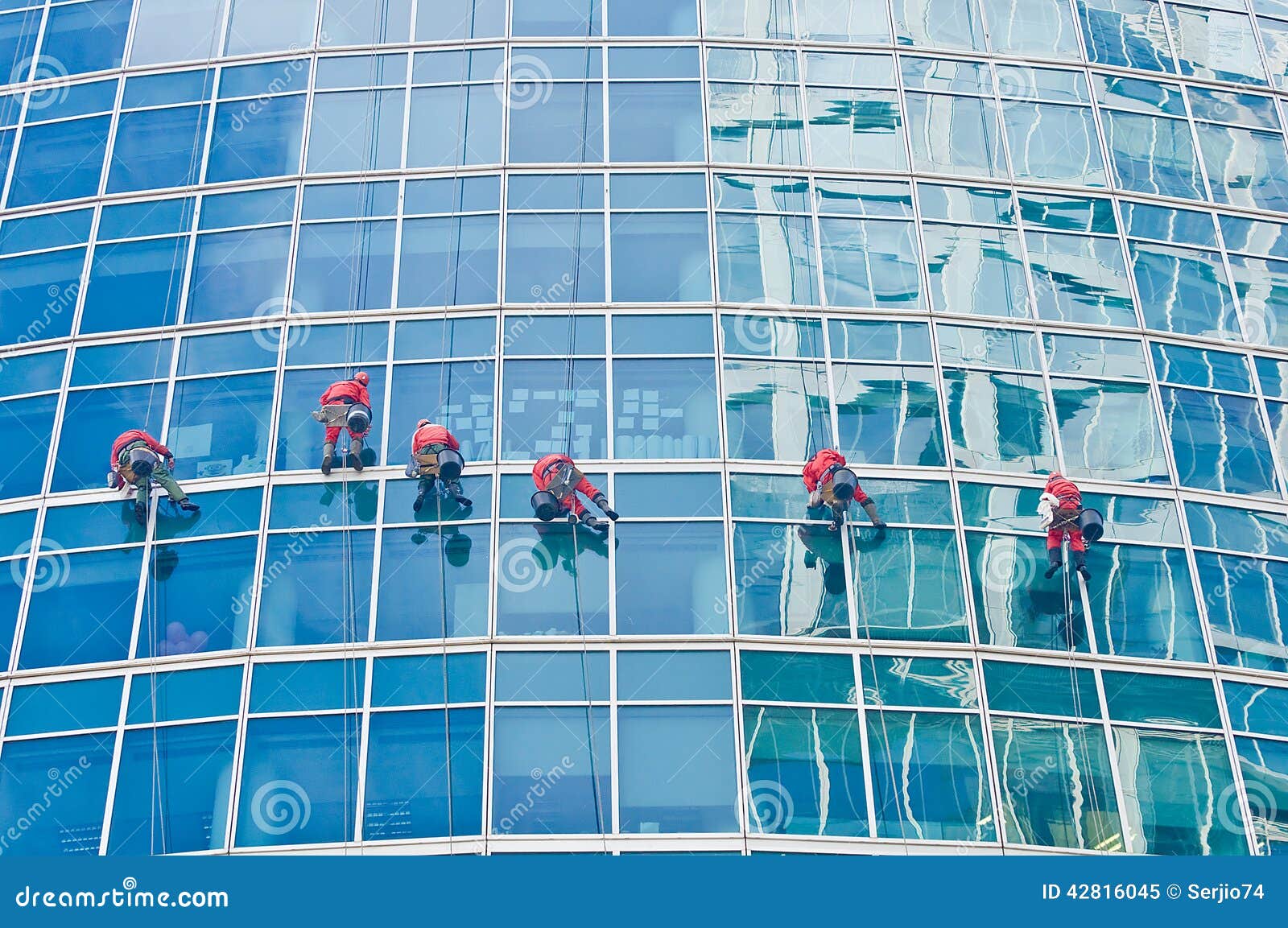 Washers Wash The Windows Of Modern Skyscraper. Window Cleaner Working ...